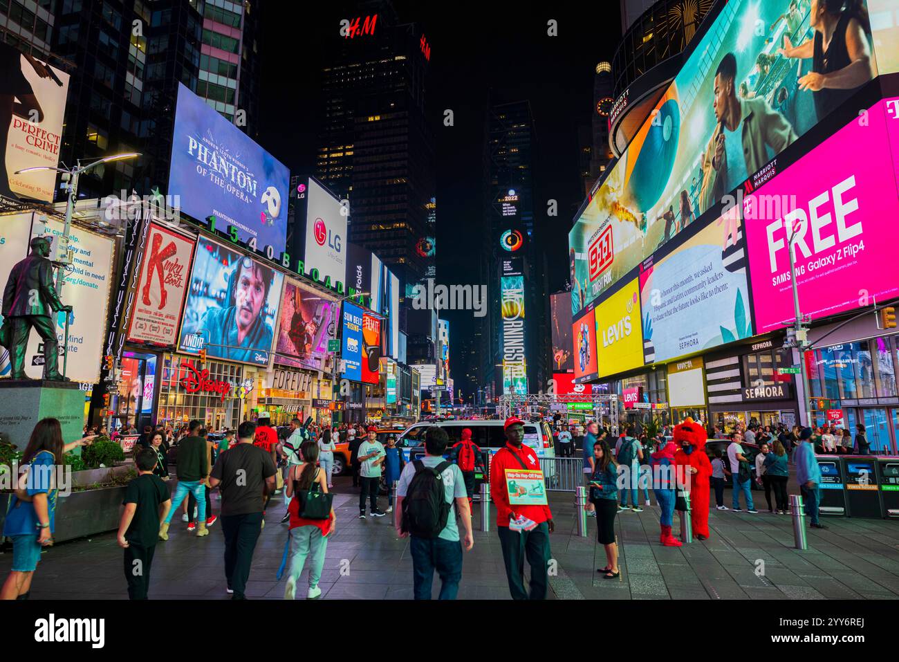 Vibrant nighttime view of Times Square filled with illuminated ...