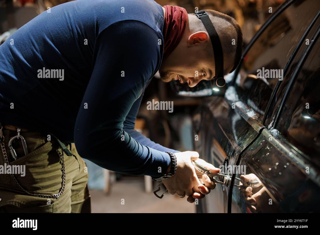 Skilled Mechanic Performing Precision Work on a Vehicle Door Lock Stock ...