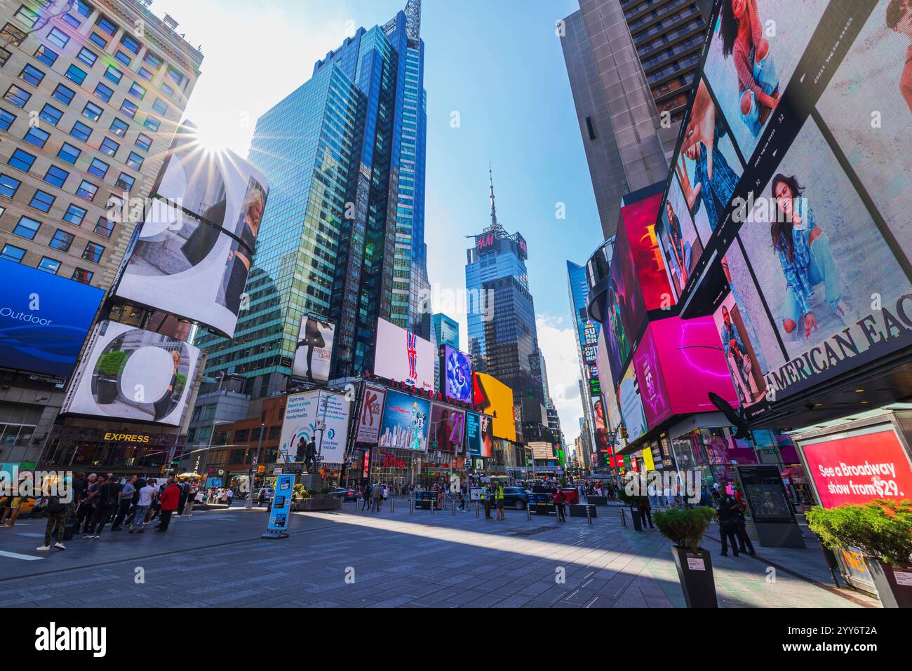 Times Square crowded with people surrounded by tall buildings and ...