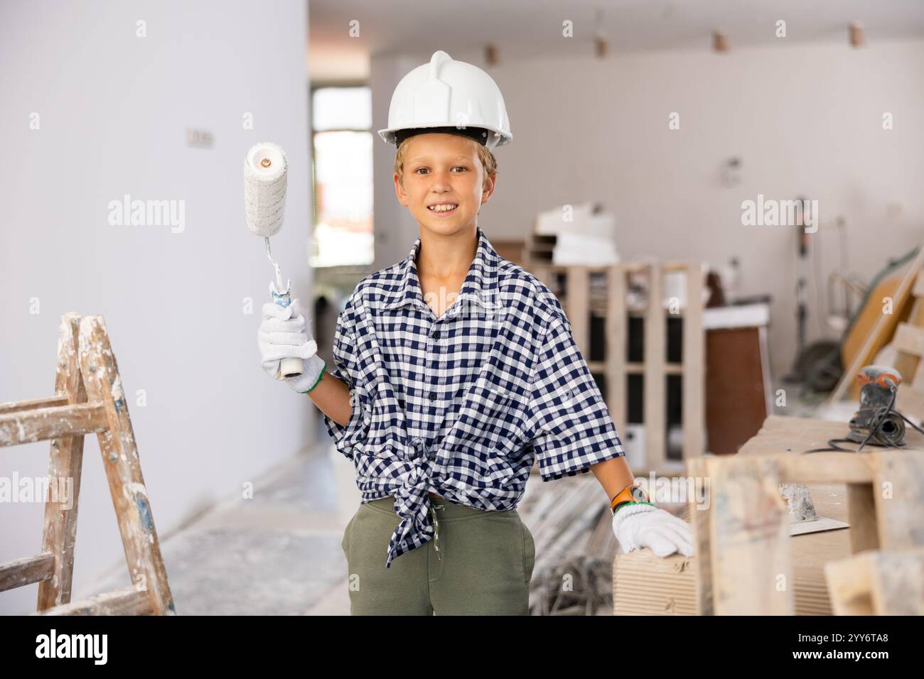 Boy posing with tools for home renovation Stock Photo - Alamy