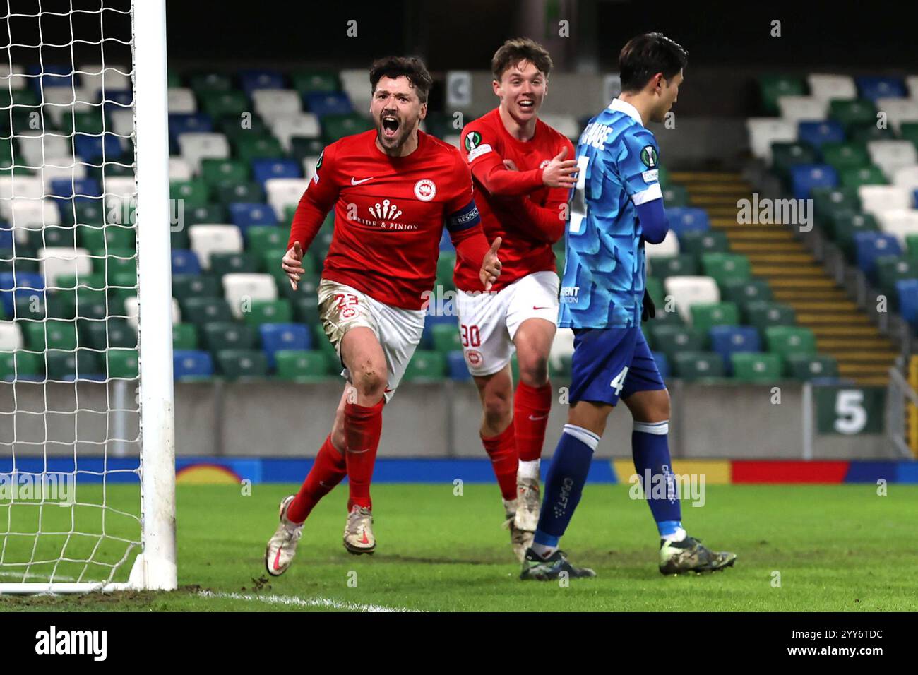 Larne's Tomas Cosgrove (left) celebrates scoring their side's first ...