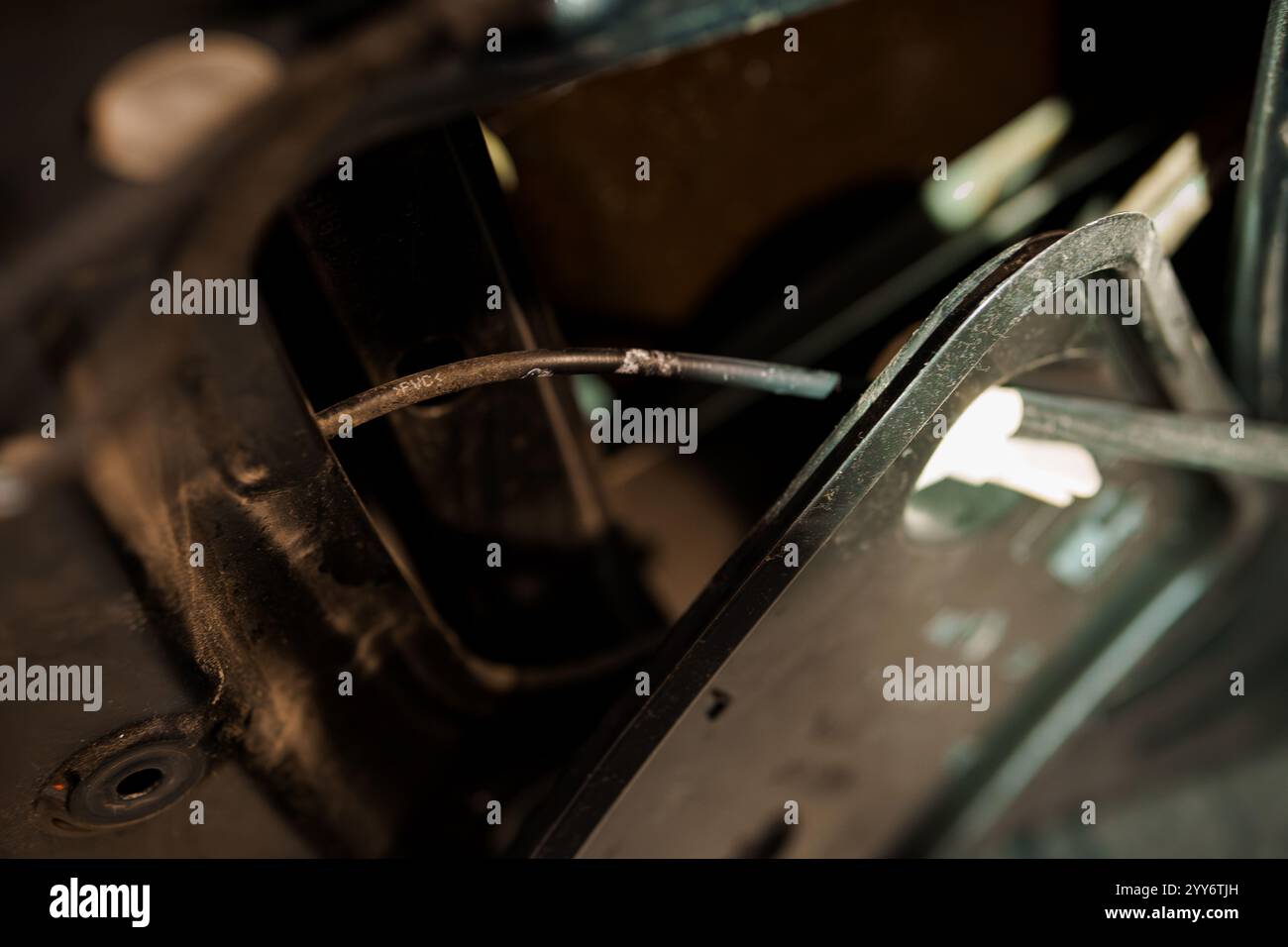 Intricate Close-Up of Car Component with Wiring and Mechanical Details ...