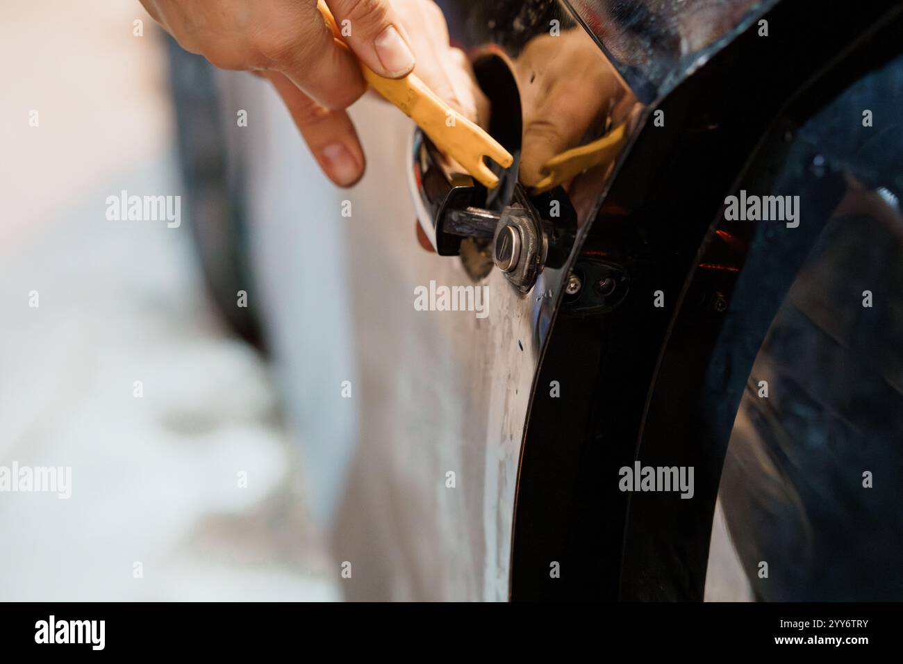 Hand Using Pliers to Open a Car Lock Stock Photo - Alamy