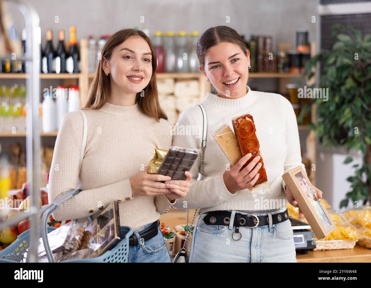 Two girls in store while shopping, choose sweets and chat sweetly Stock ...