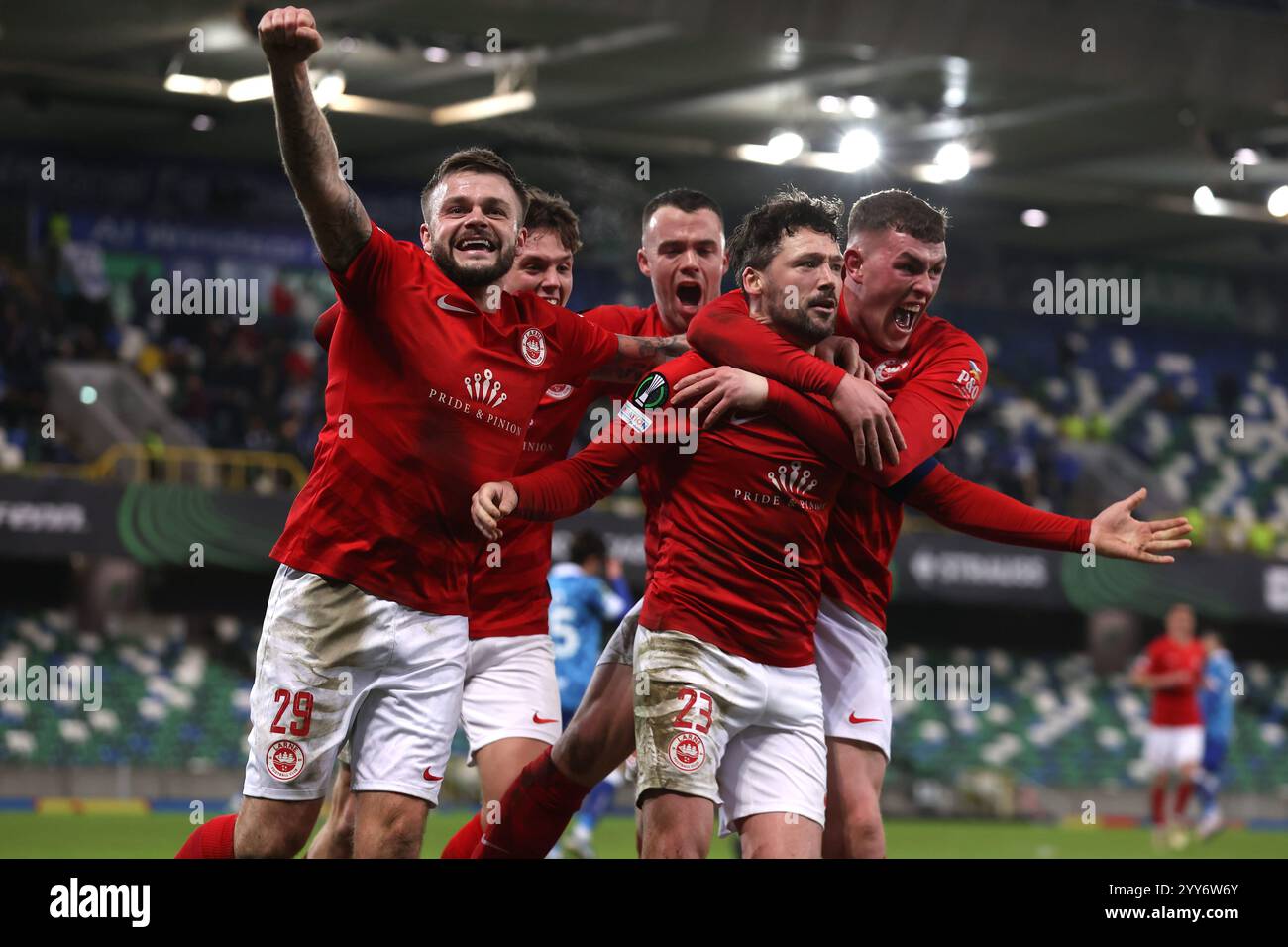 Larne's Tomas Cosgrove (second right) celebrates scoring their side's ...