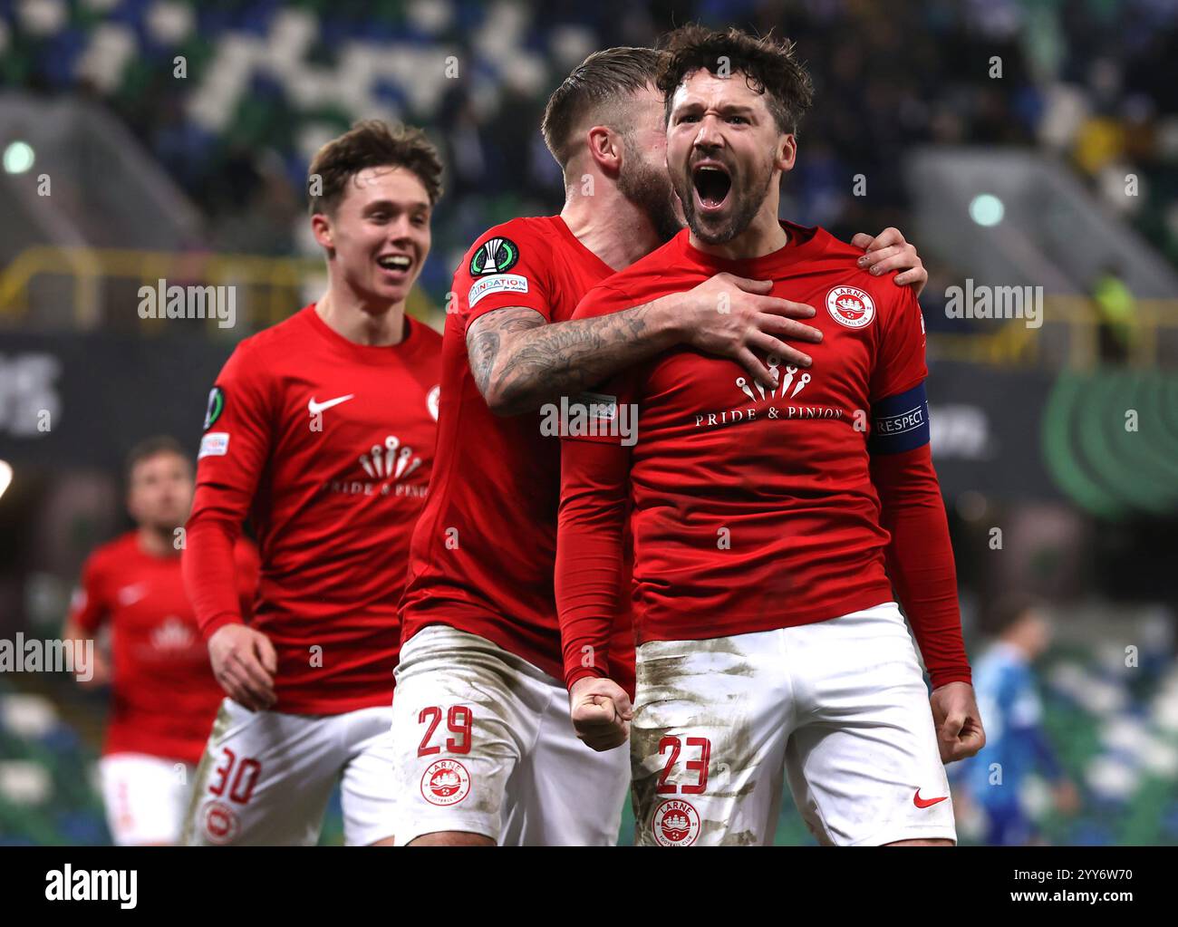 Larne's Tomas Cosgrove (right) celebrates scoring their side's first ...