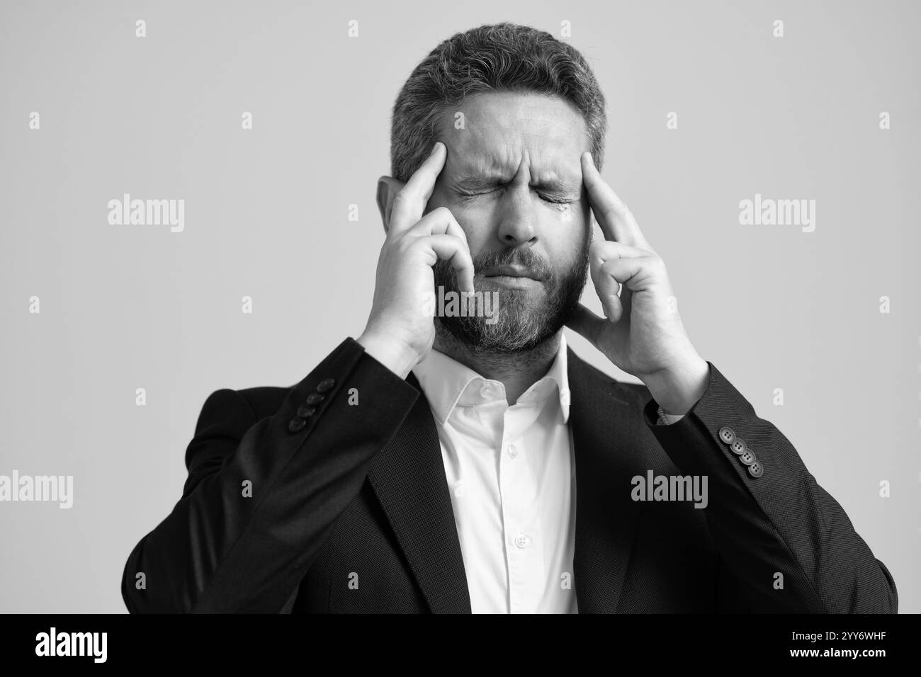 Headache, tiredness and stress. Businessman in suit with headache ...