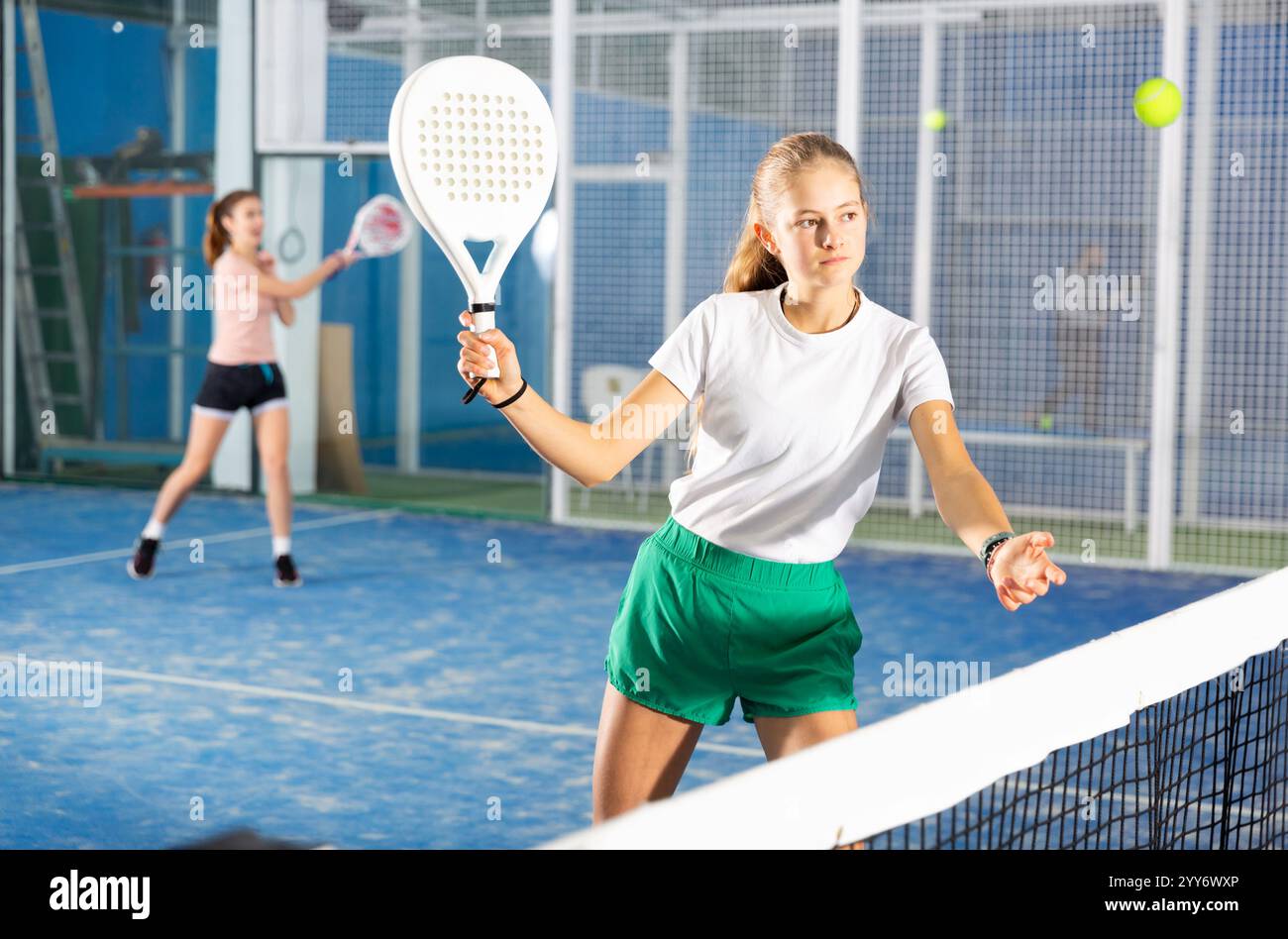 Teenage girl playing padel game on court Stock Photo - Alamy