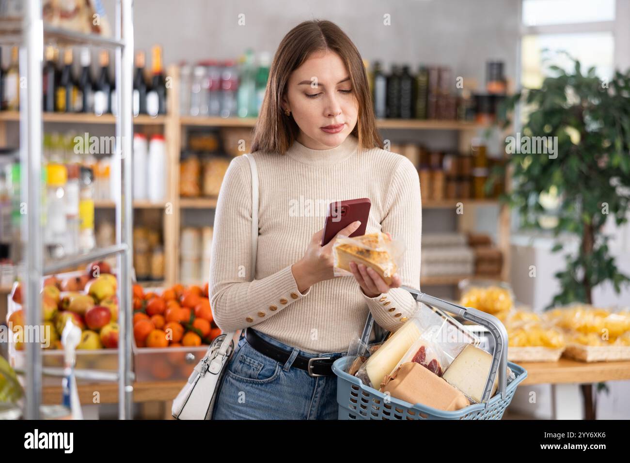 Young woman scanning qr code of cheese Stock Photo - Alamy