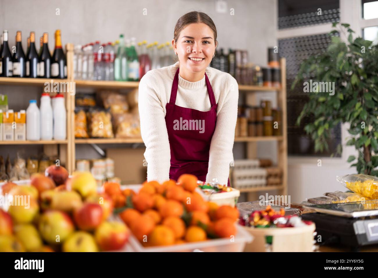 Smiling saleswoman behind the store counter Stock Photo - Alamy
