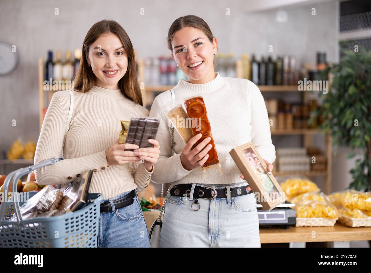 Two girls in store while shopping, choose sweets and chat sweetly Stock ...