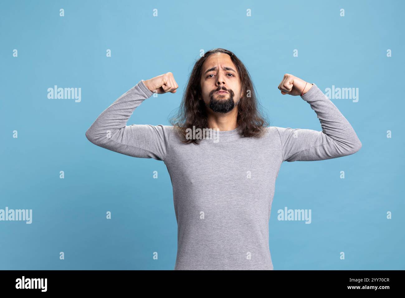 Athletic person flexing his biceps muscles in front of the camera ...