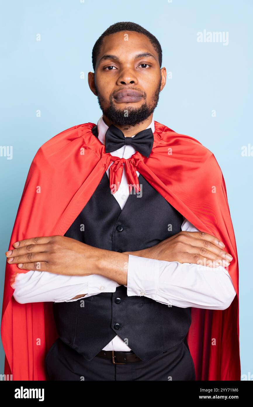African american doorman posing in a superhero red mantle in studio ...
