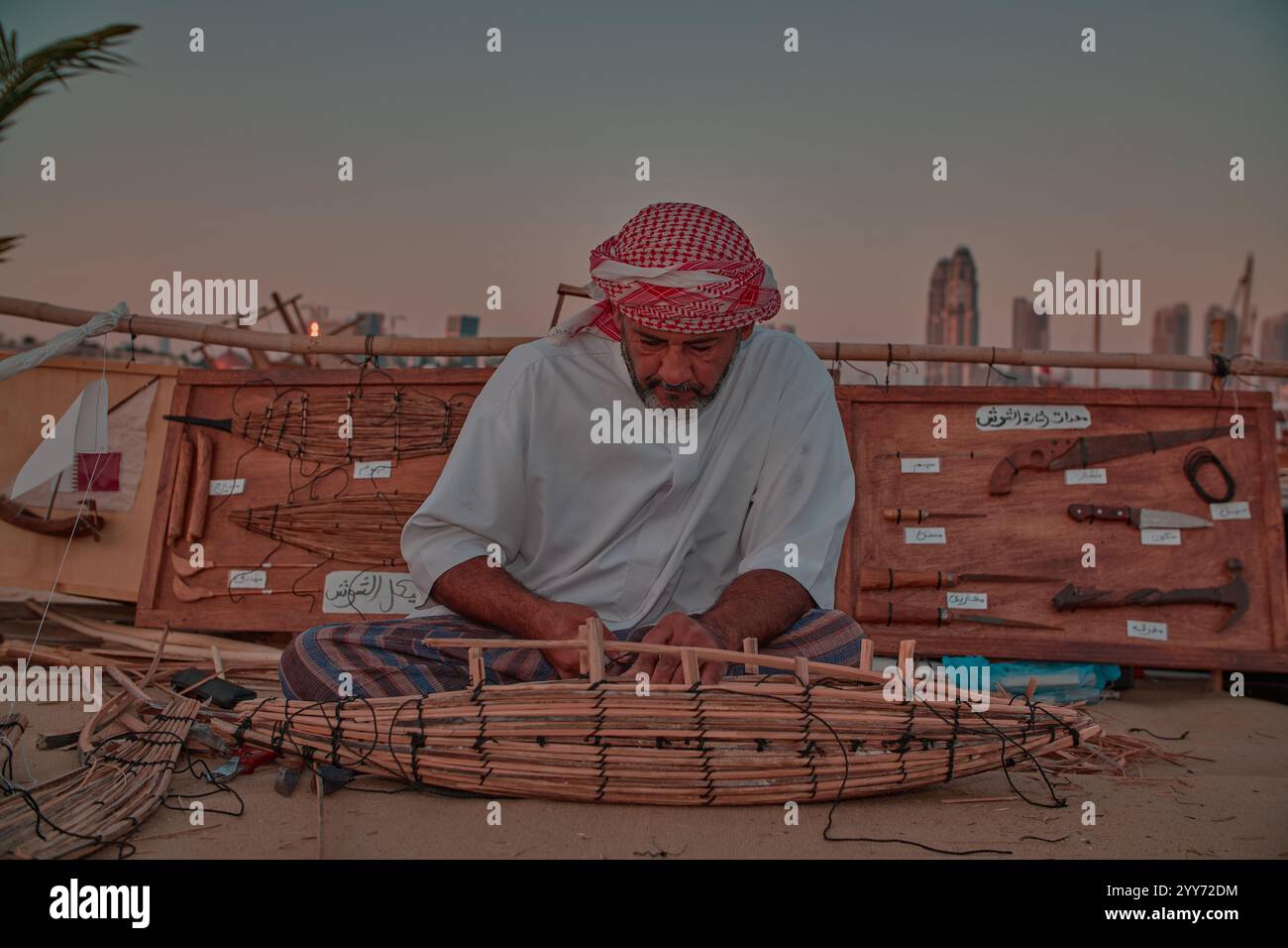 Traditional Arabic carpenter (dhow maker) working in Katara cultural ...