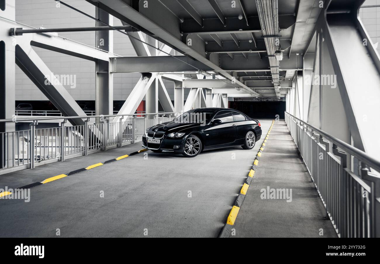 Black BMW on a metal truss bridge. Three quarter front view of german ...