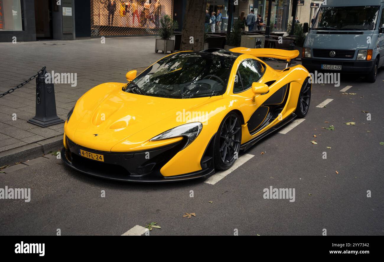 McLaren P1 parked on the street. Yellow british hypercar on the street ...