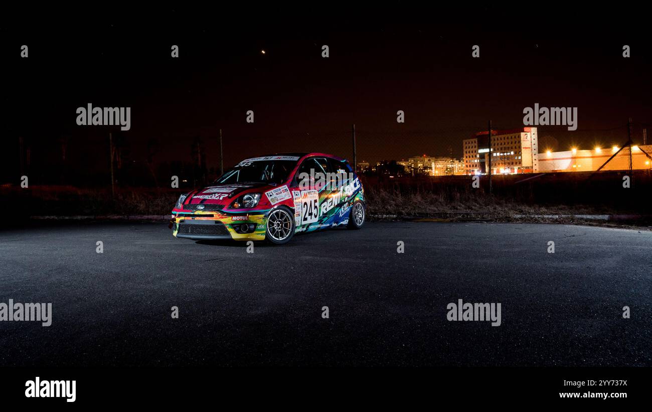 Ford Fiesta racecar at night. Three quarter front view of mall and ...