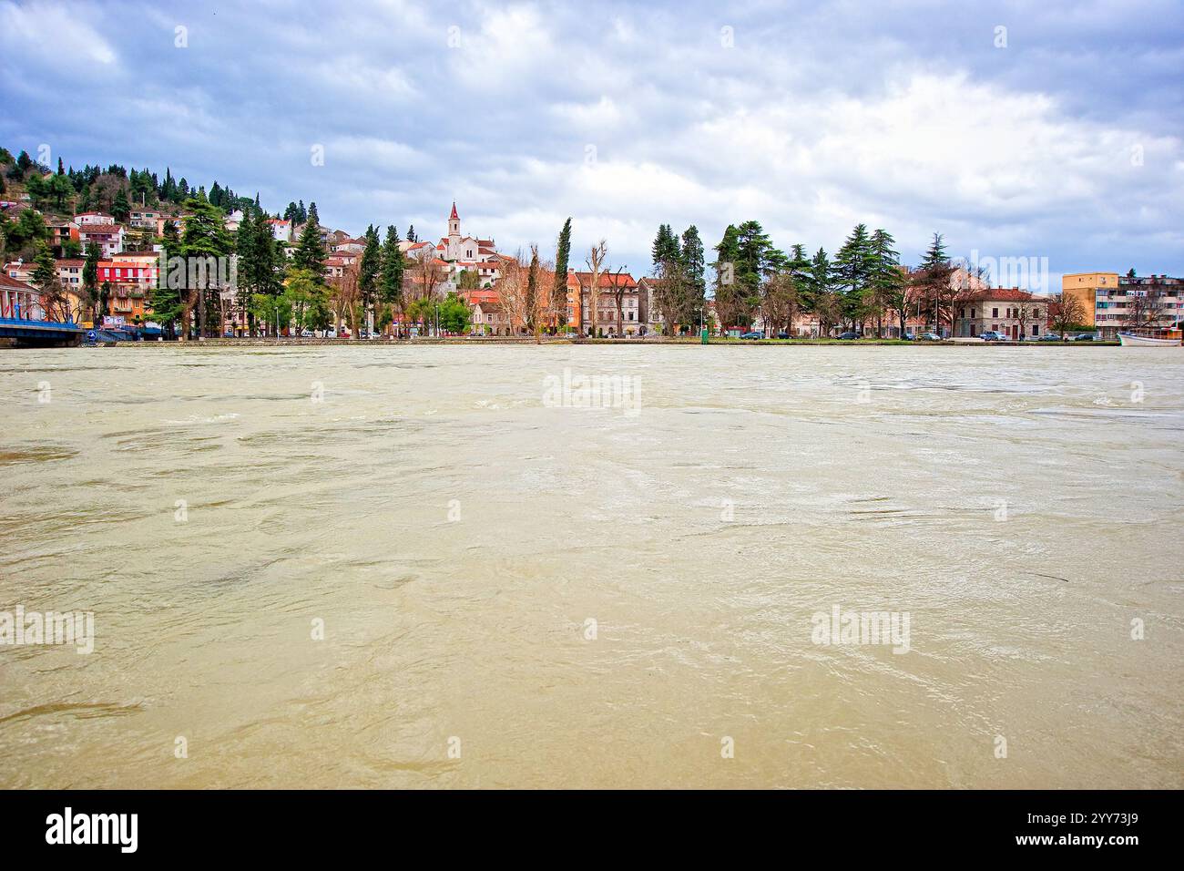 Small Mediterranean town along the swollen river and threatening flood ...