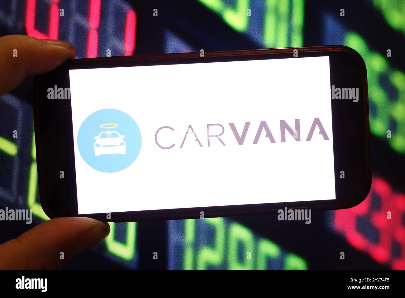 In this photo illustration, the Carvana company logo is seen displayed ...