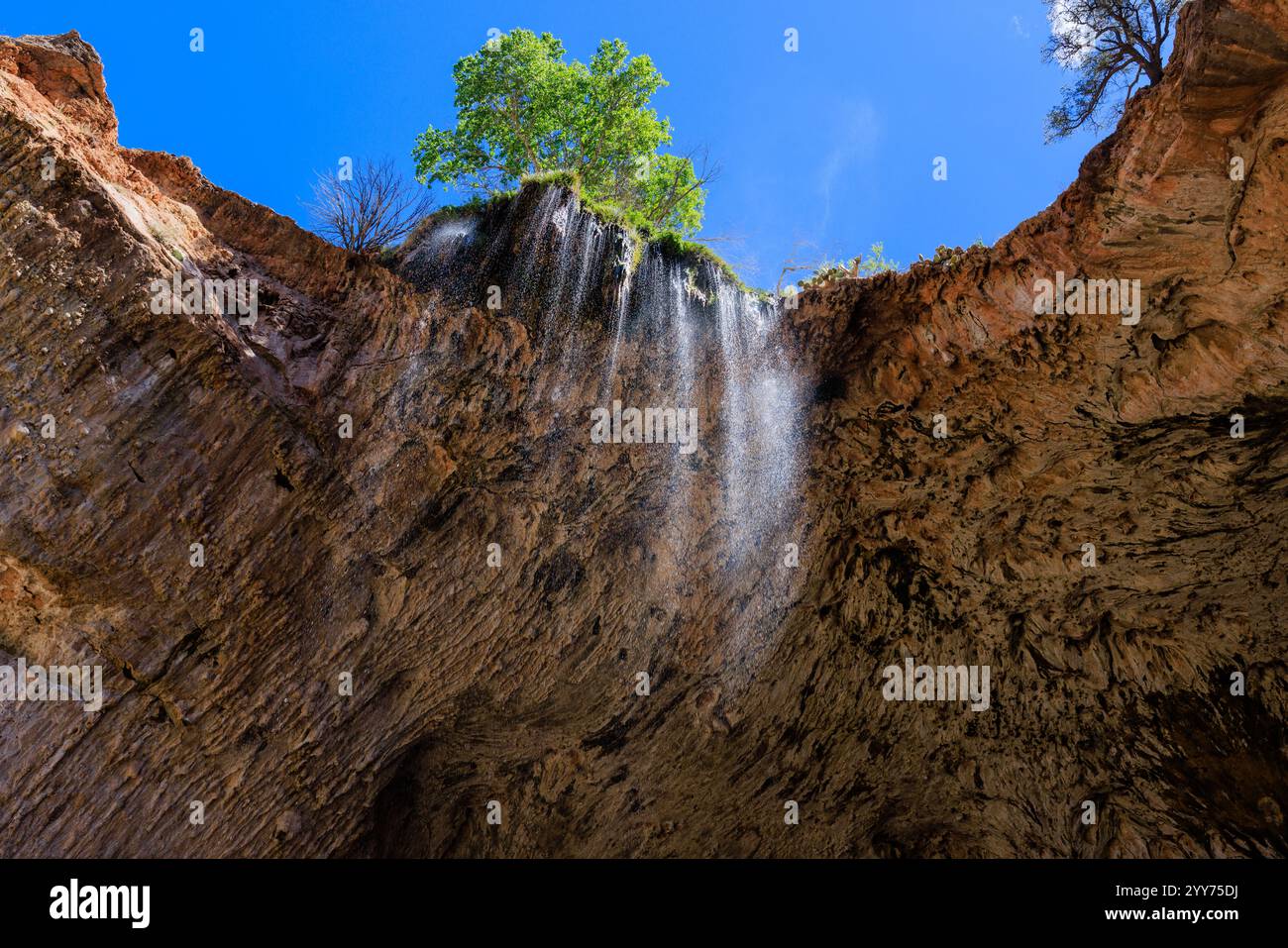 The view looking up as water cascades off of the travertine natural ...