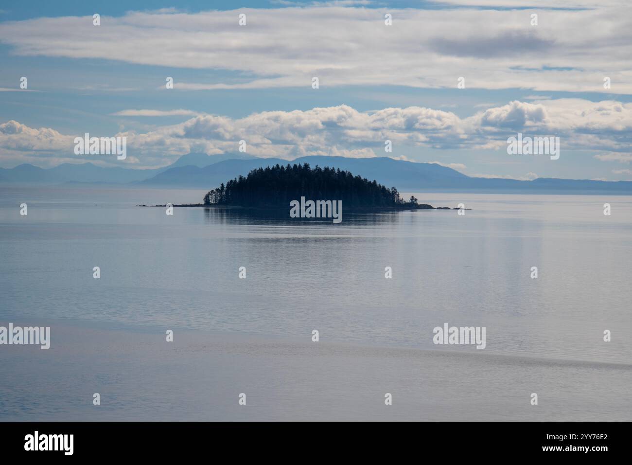 Beautiful and peaceful scene of a tiny island with an iconic evergreen ...