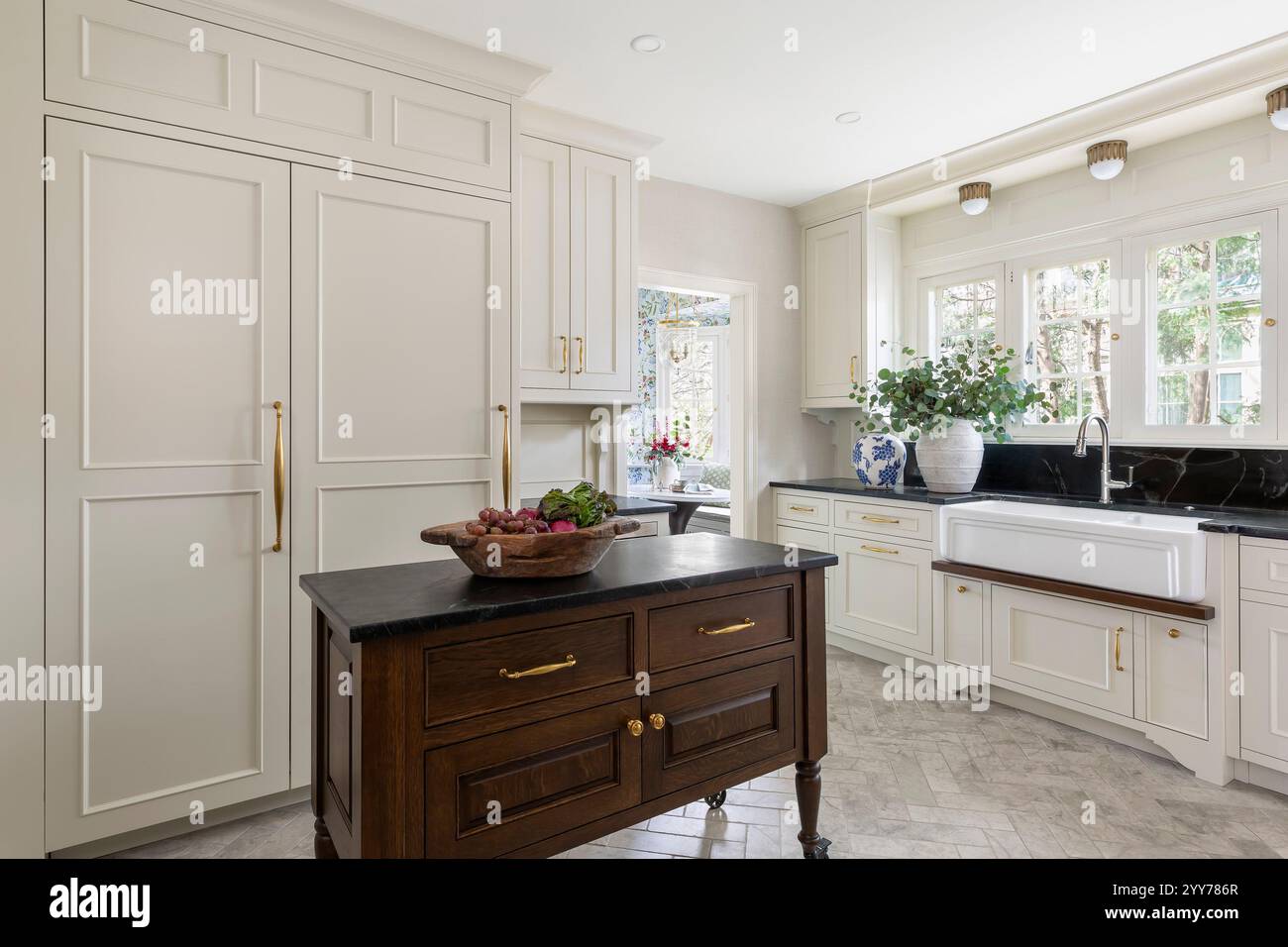 Traditional high end kitchen with small custom island and large ...