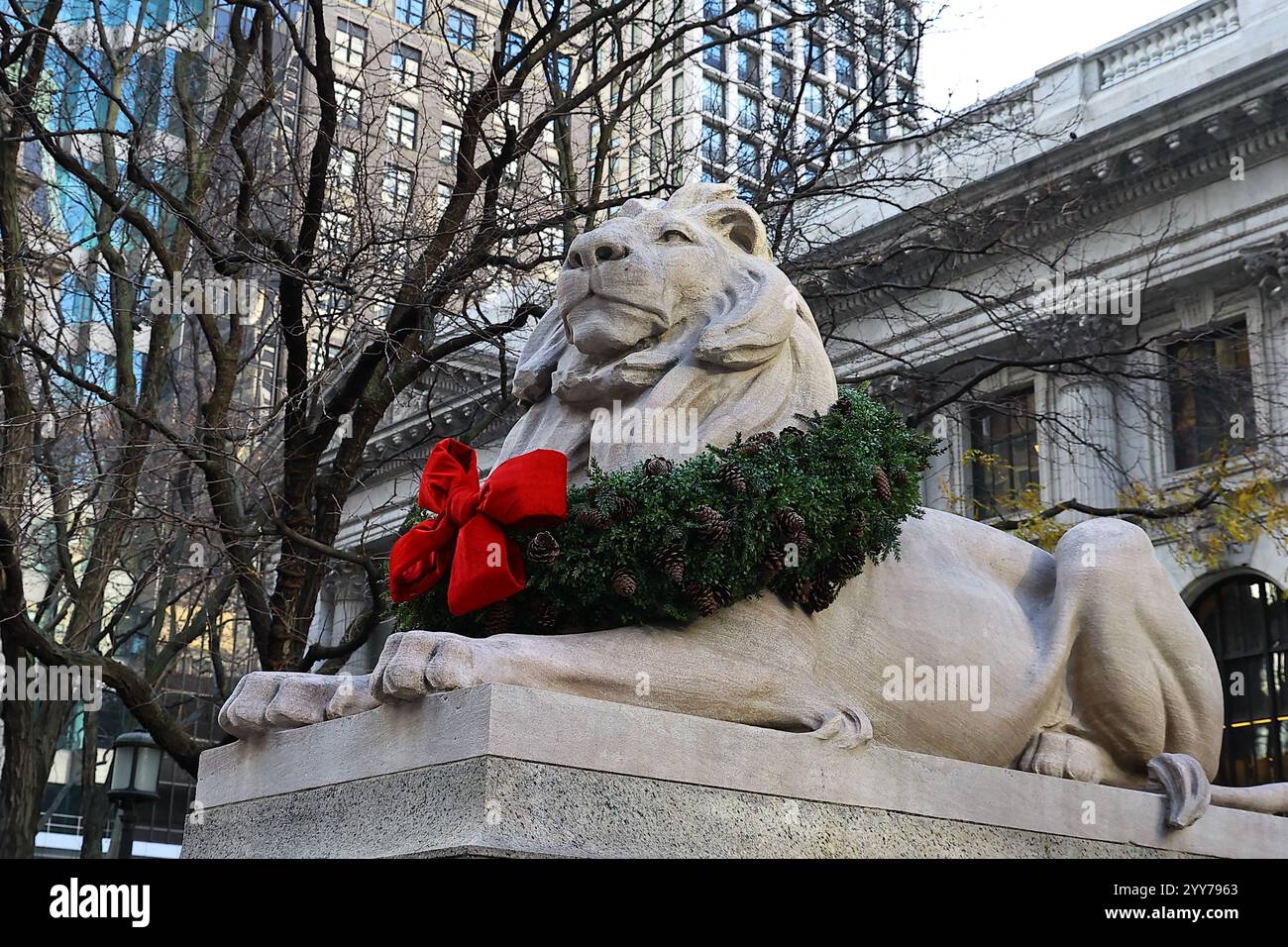 The statue of Patience the lion wears a Christmas wreath around its ...
