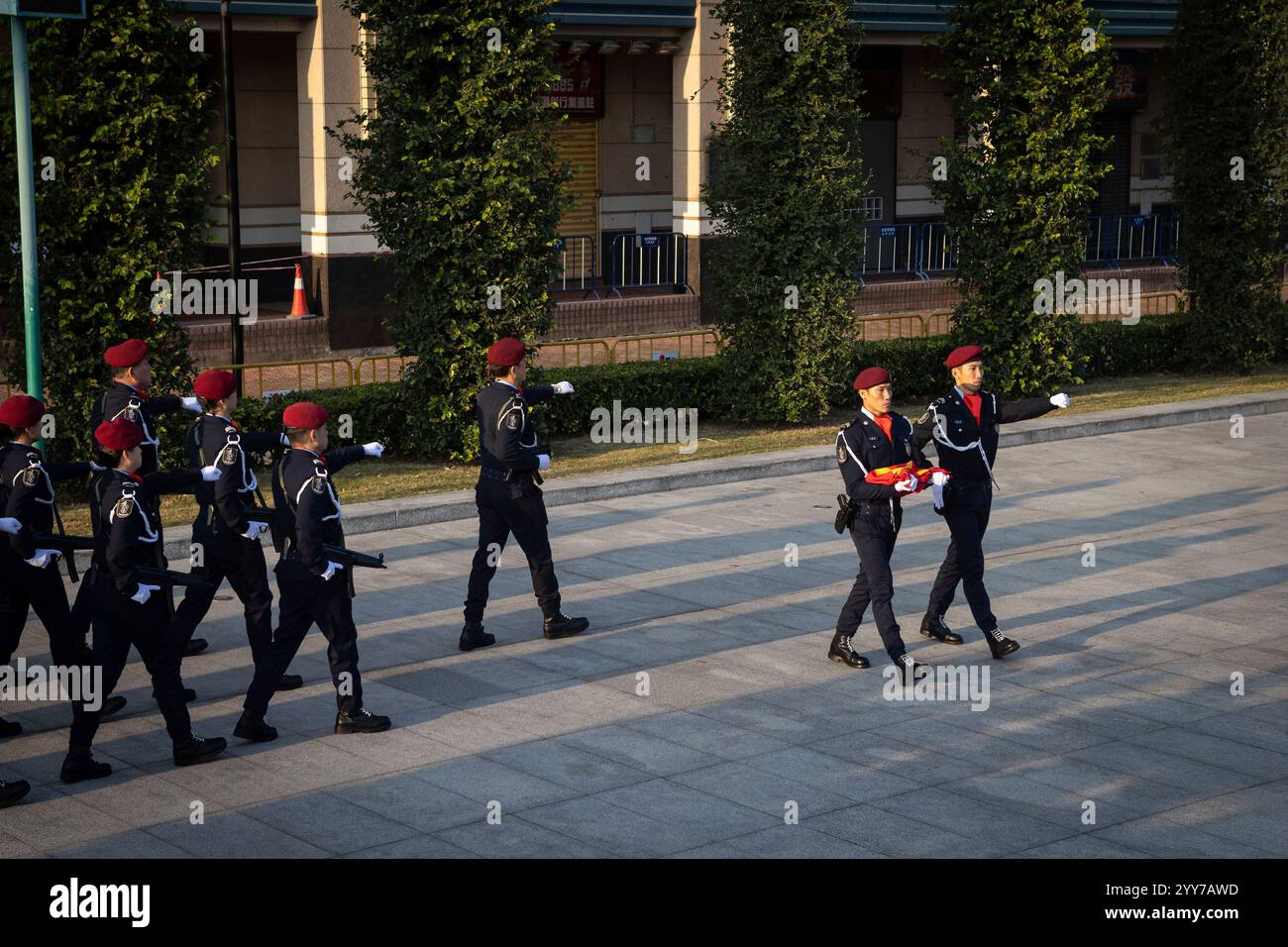 Security forces carry the Chinese and Macau flags before a flag-raising ...