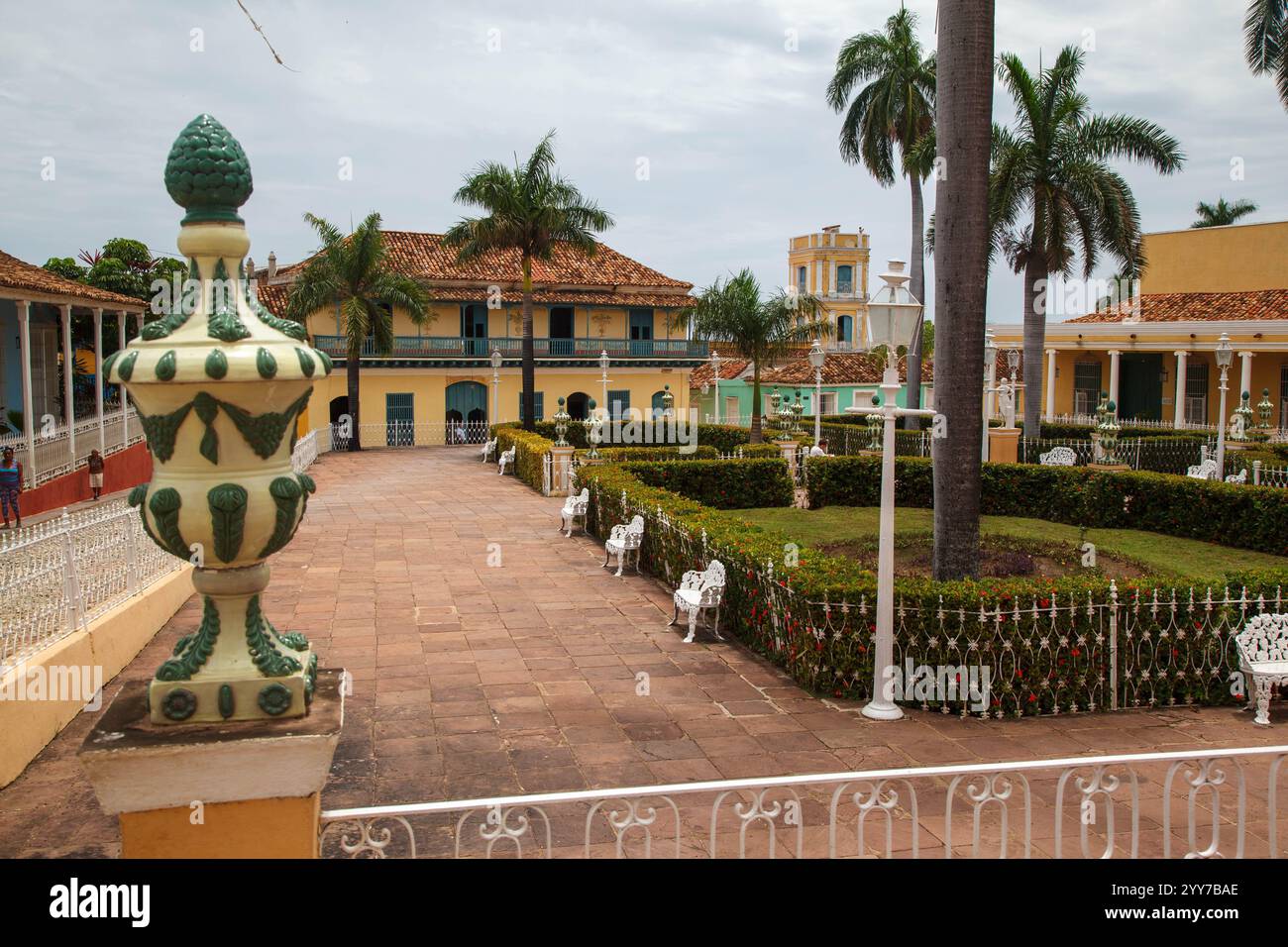 An ornate ceramic vase and Plaza Mayor with white iron benches and the ...