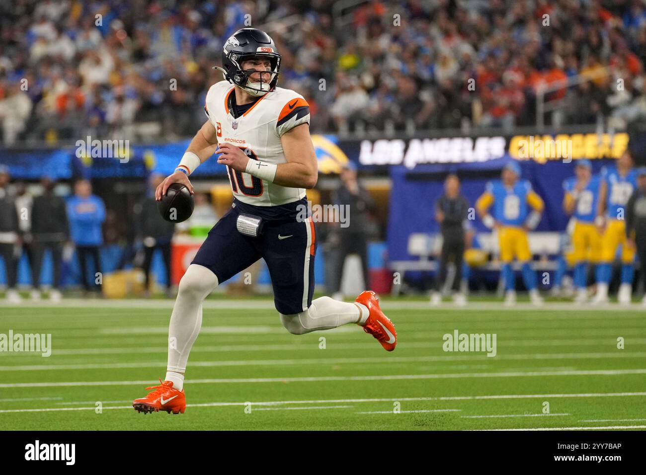 Denver Broncos quarterback Bo Nix rolls out near the end zone during ...