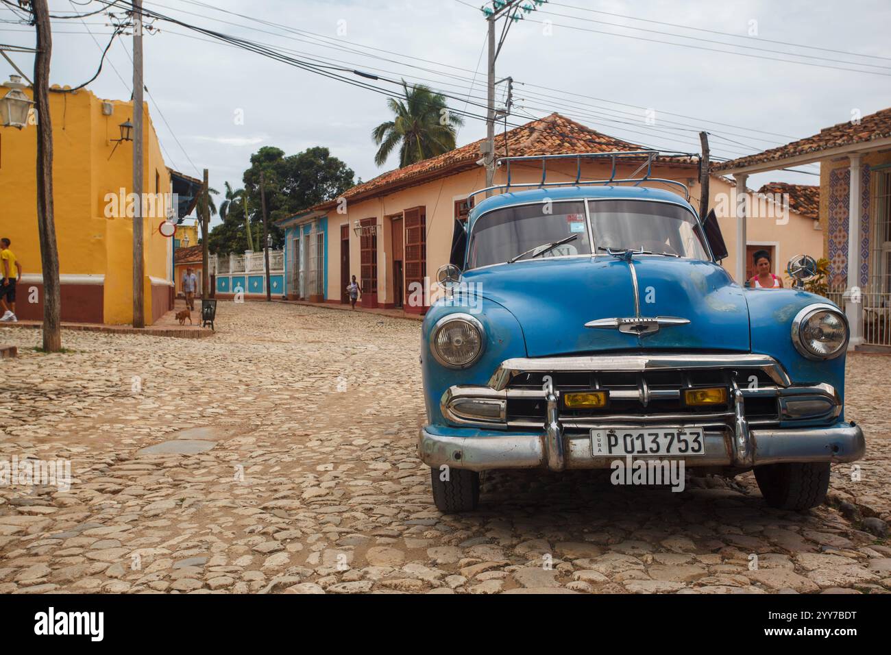 A Vintage blue chevrolet car in a typical cobblestone street with ...