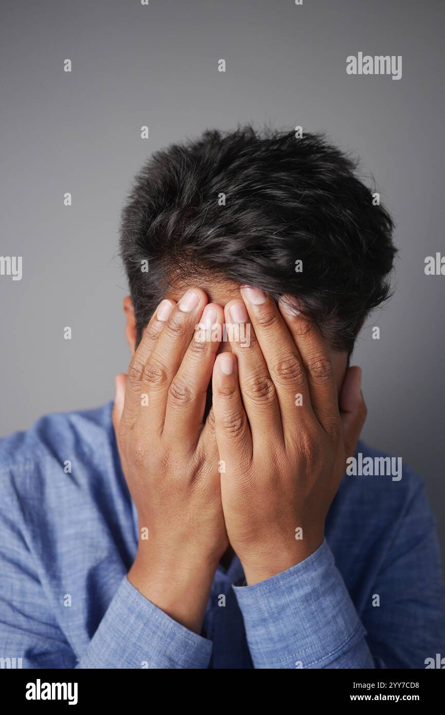 Close up of sad man covering face with hand Stock Photo - Alamy