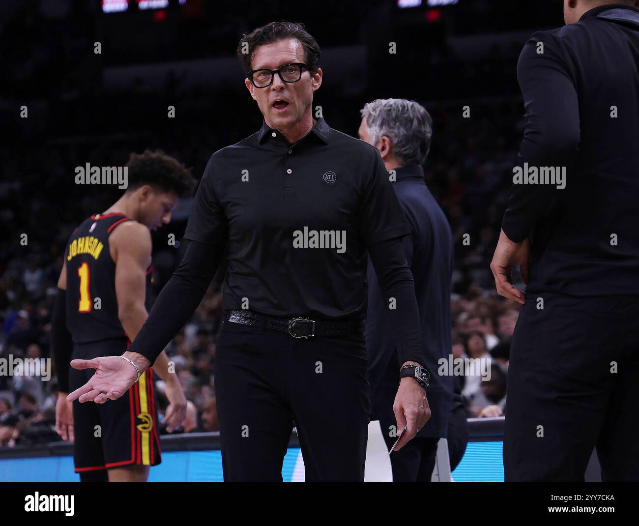 Atlanta Hawks head coach Quin Snyder, center, converses with a game ...