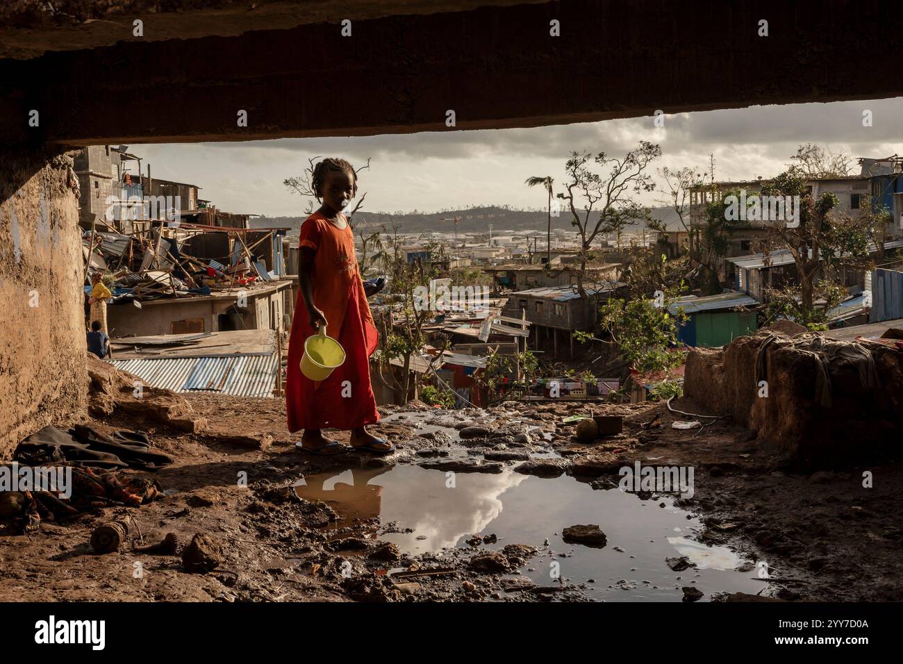 A girl walks in the Kaweni slum on the outskirts of Mamoudzou, in the ...