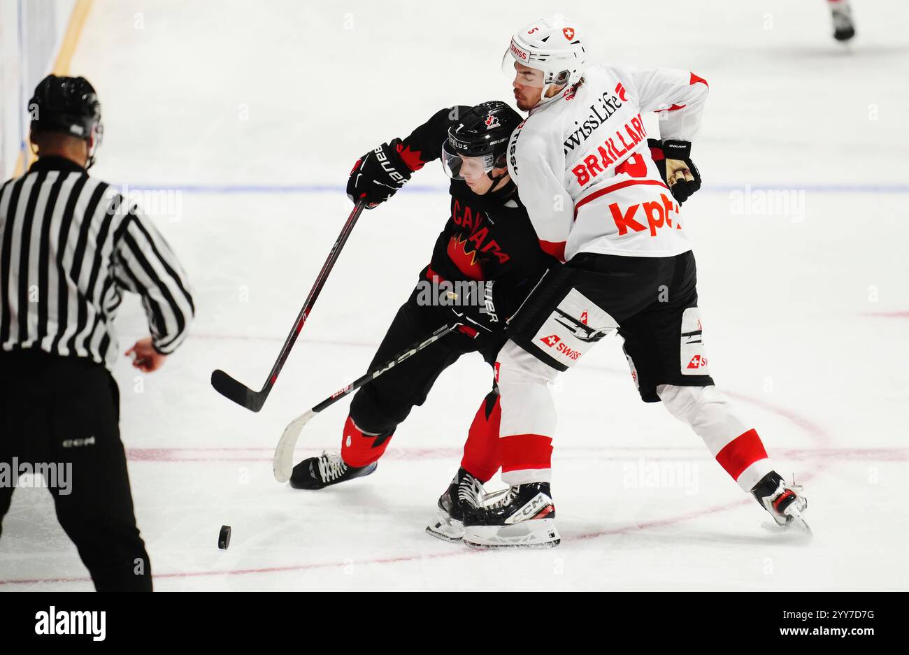 Canada's Sawyer Mynio, left, leans into Switzerland's Leo Braillard (5 ...