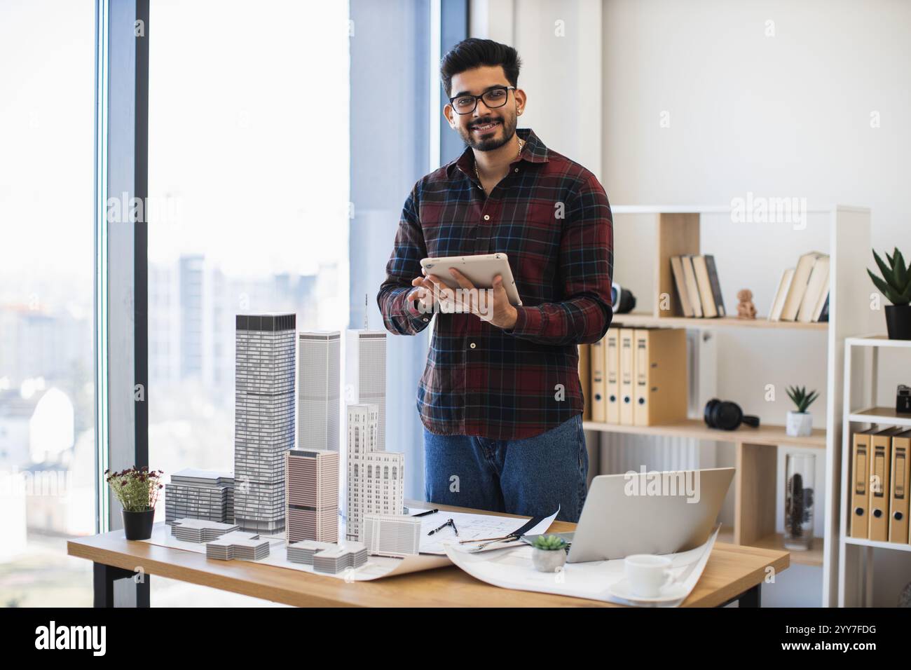 Indian male architect develops modern city project using digital tablet ...