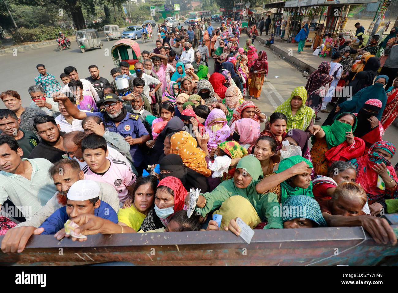 December 19, 2024, Dhaka, Bangladesh: Bangladeshi people wait in a queue to buy essentials from ...