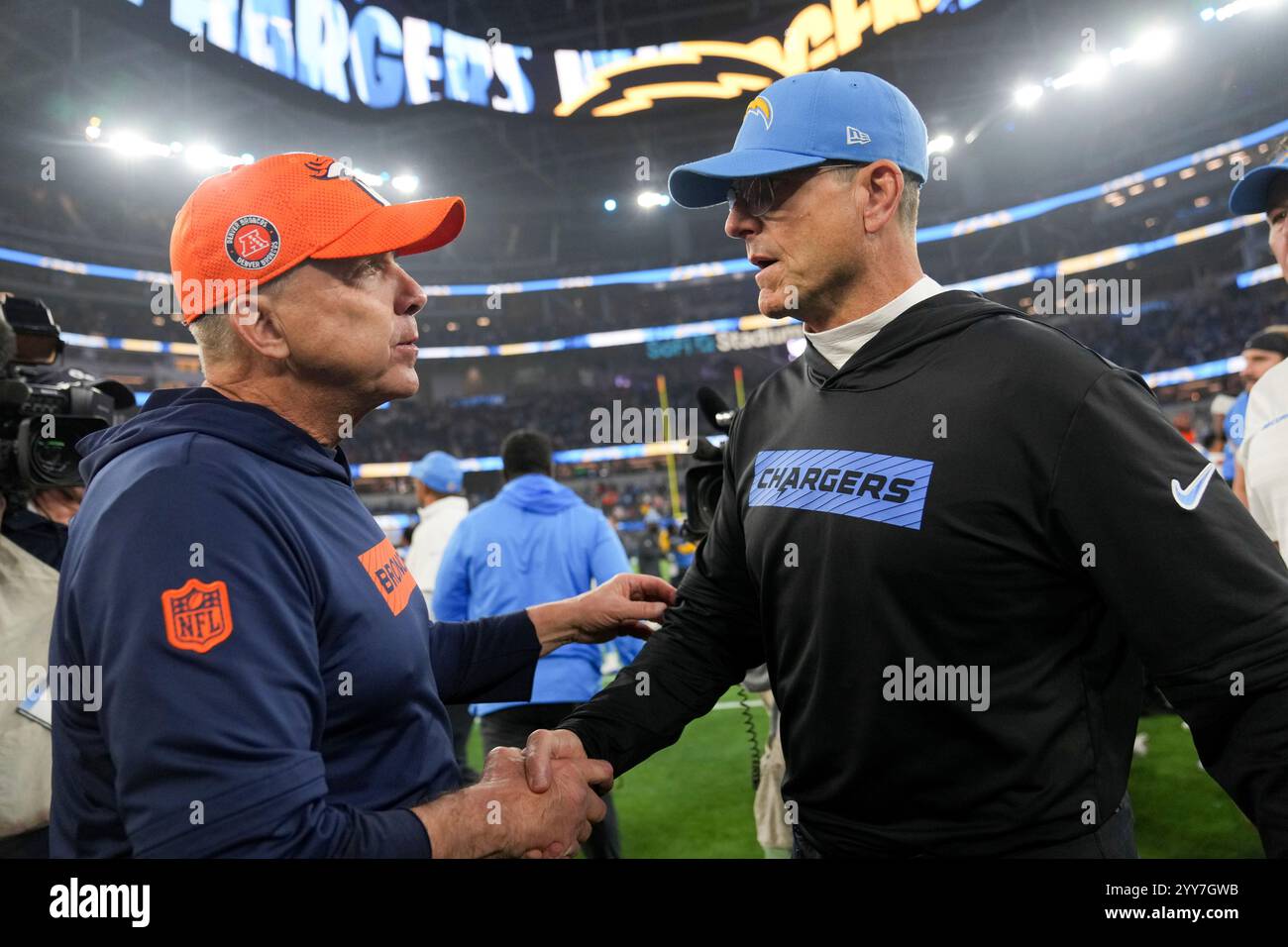 Denver Broncos head coach Sean Payton, left, shakes hands with Los Angeles Chargers head coach ...