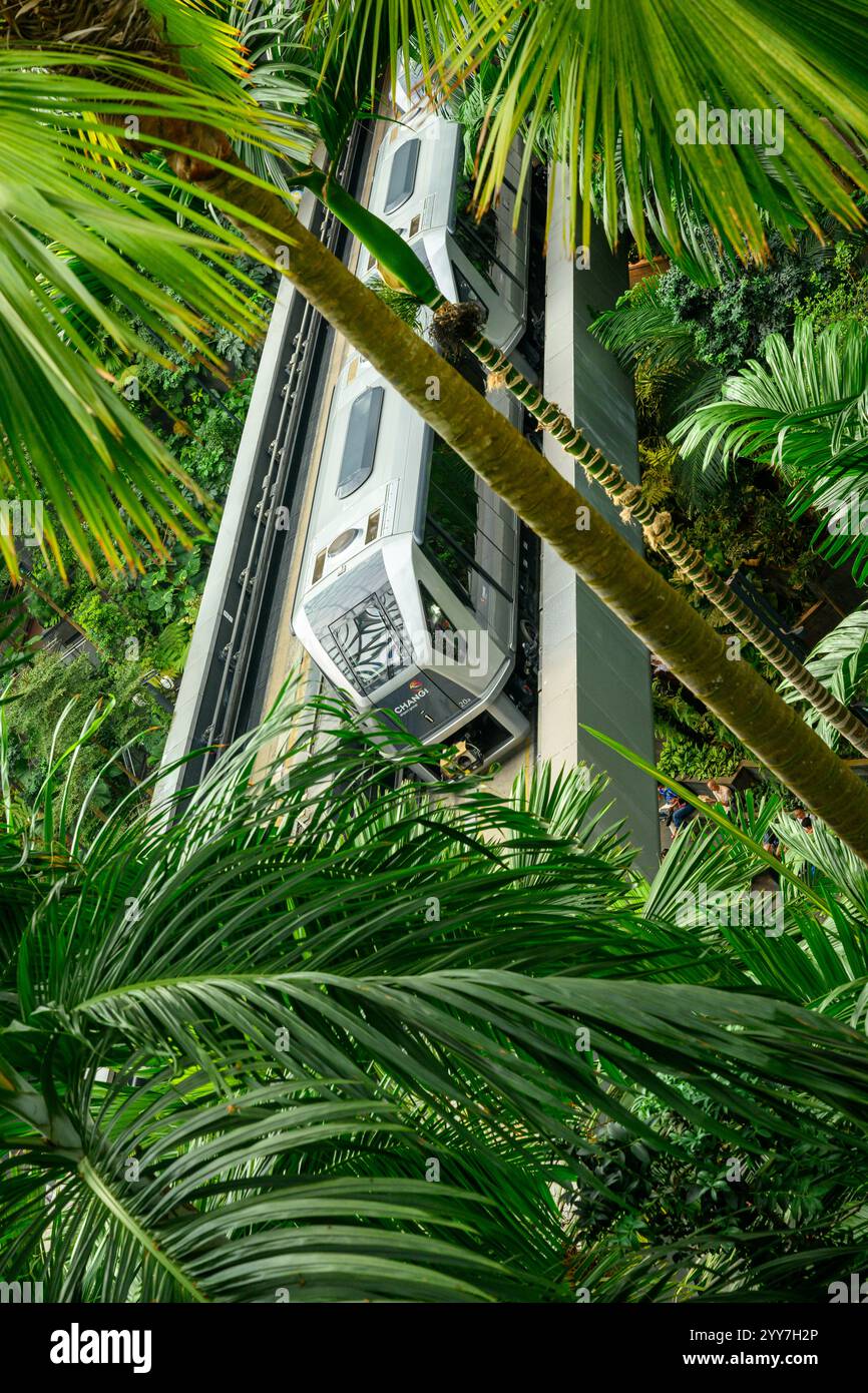 The Changi Airport Skytrain passing through The Jewel Rain Vortex ...