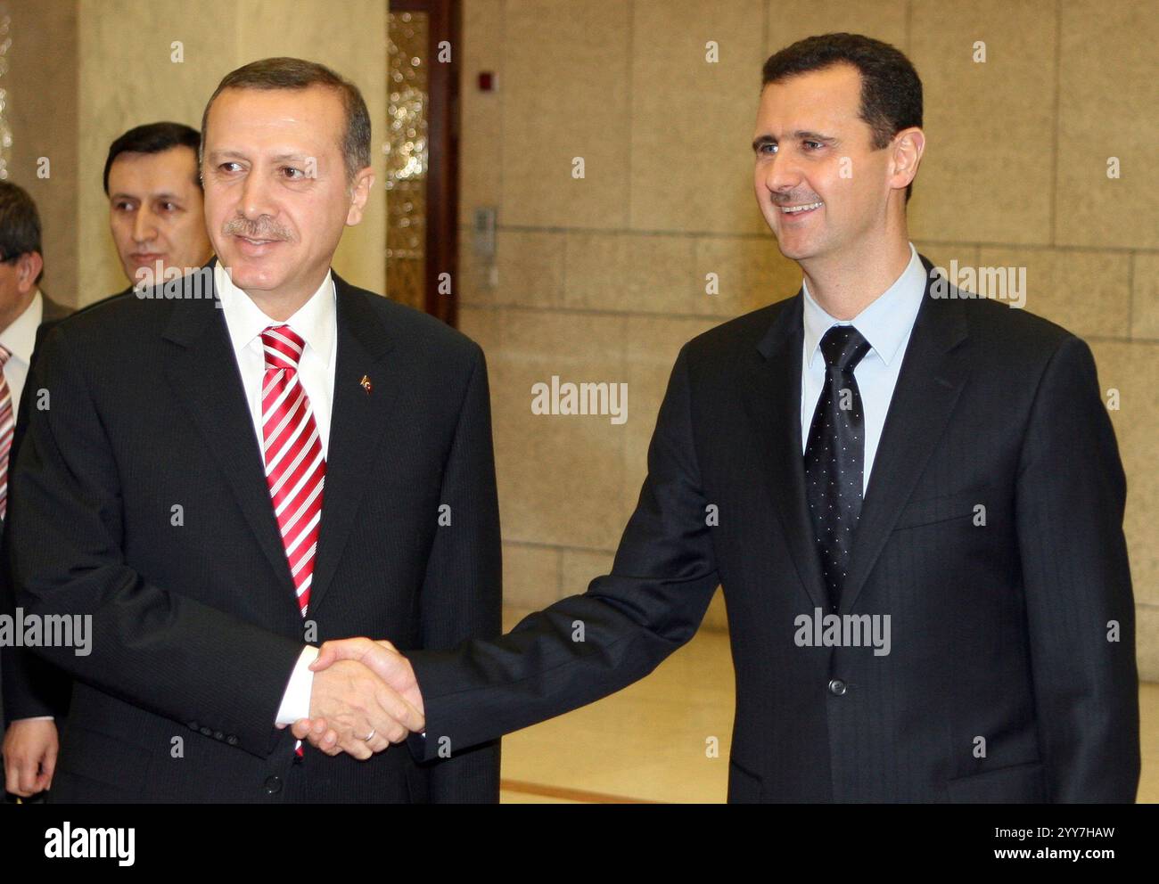 FILE - Syrian President Bashar Assad, right, shakes hands with Turkish ...