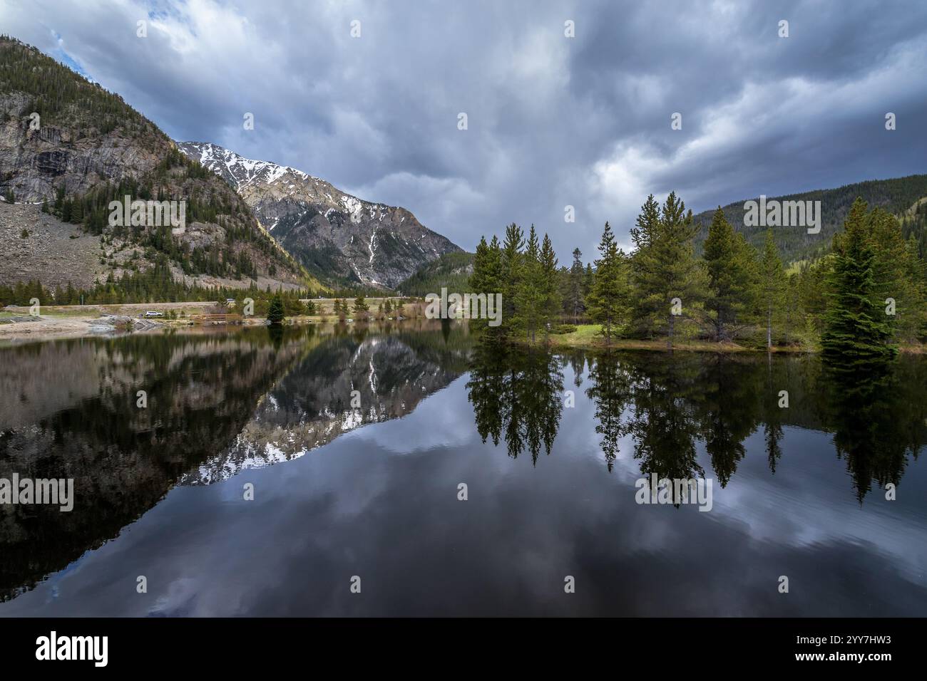 Clear waters of Officers Gulch Pond mirror the stunning Rocky Mountains ...