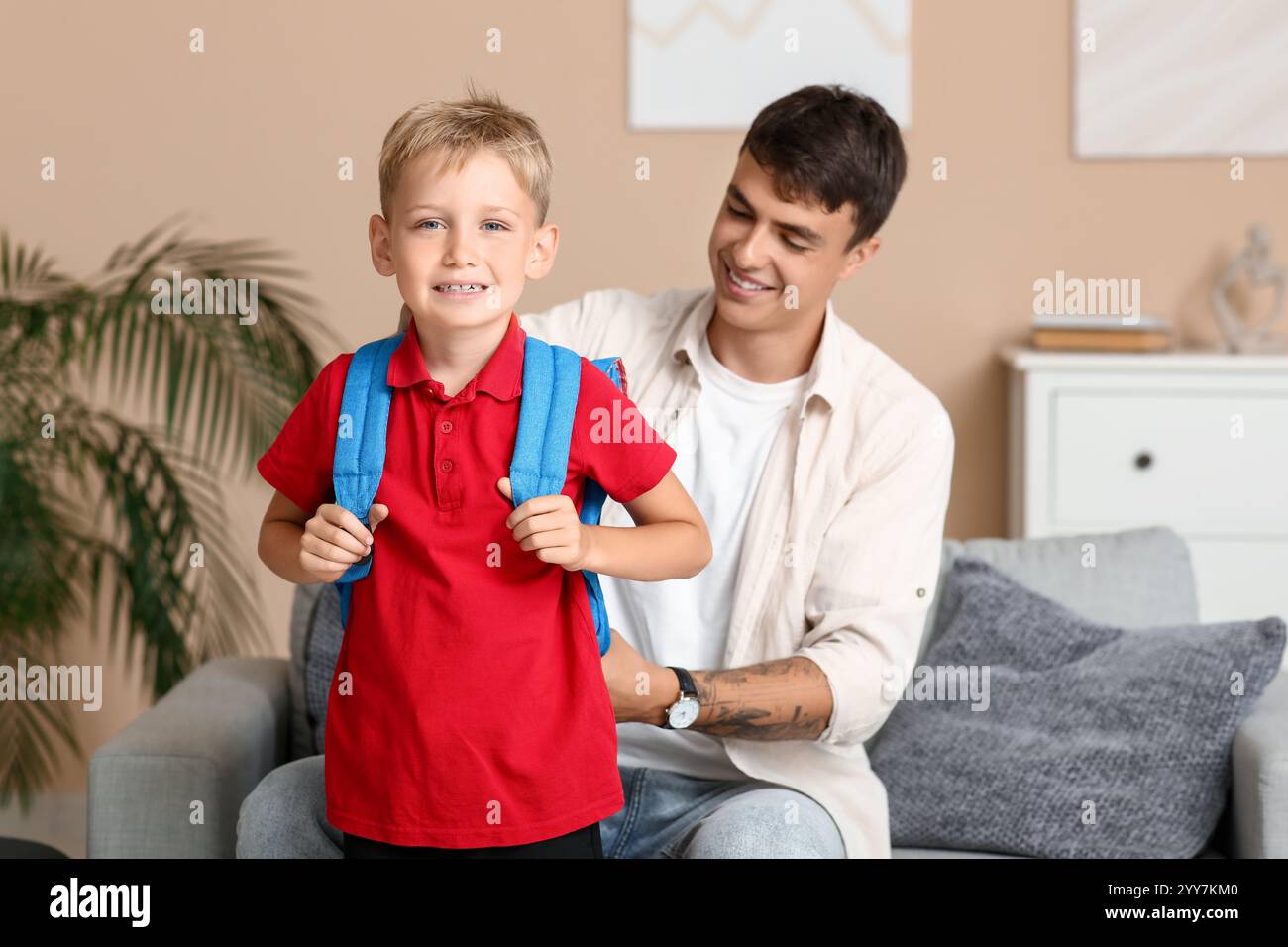 Father adjusting his little son's backpack at home Stock Photo - Alamy