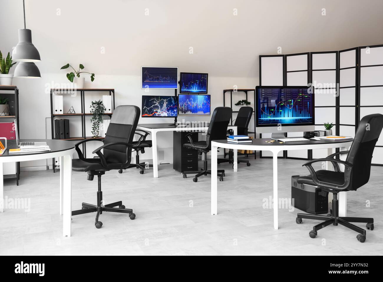 Interior of trader's office with desks and shelf units Stock Photo - Alamy