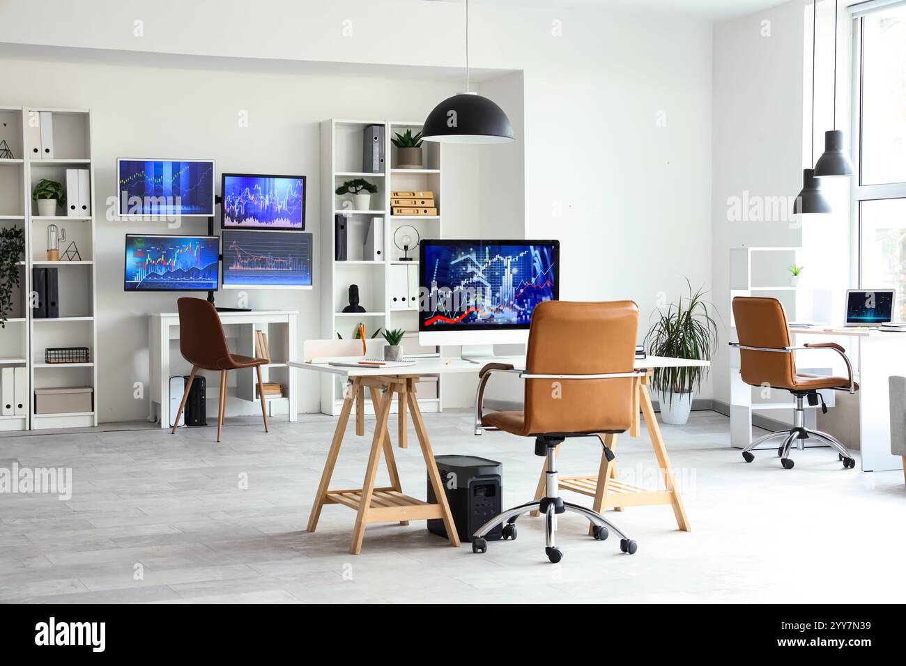 Interior of trader's office with desks and shelf units Stock Photo - Alamy