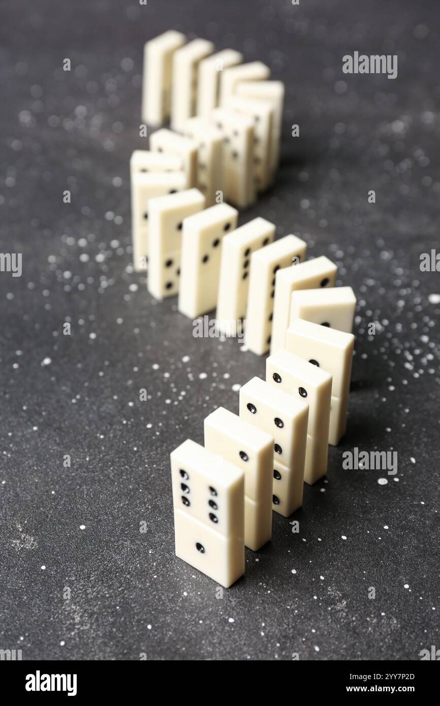 Many white dominos blocks on black background Stock Photo - Alamy