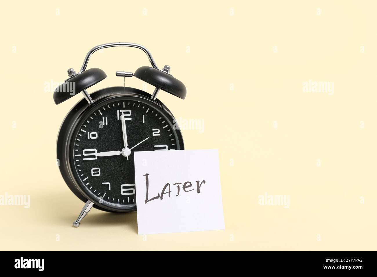 Paper sheet with word LATER and alarm clock on color background Stock ...