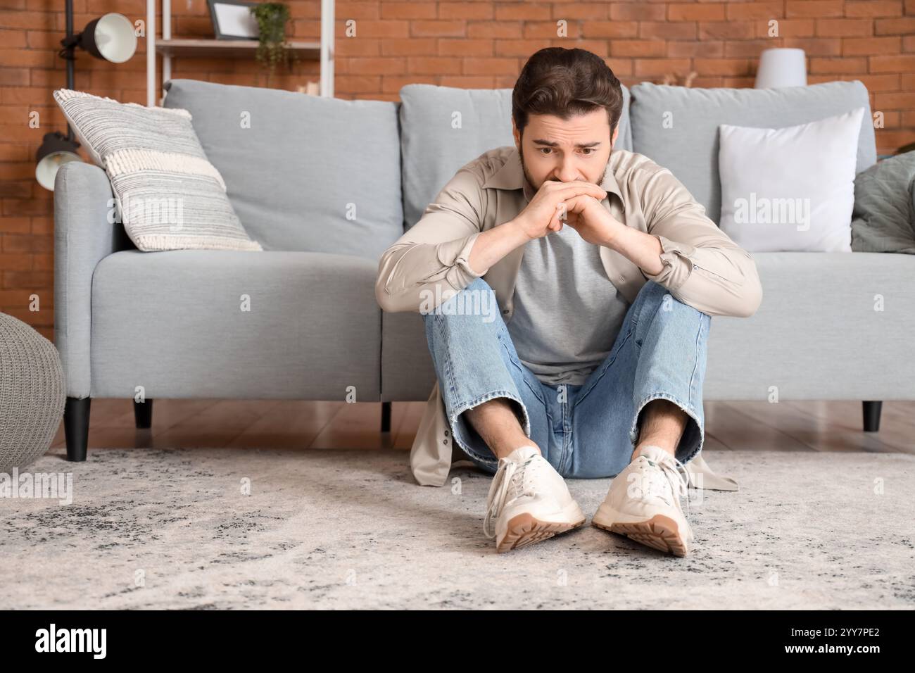 Portrait of worried man at home Stock Photo - Alamy