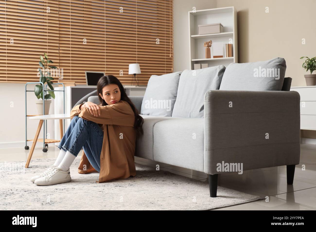 Portrait of worried young woman at home Stock Photo - Alamy