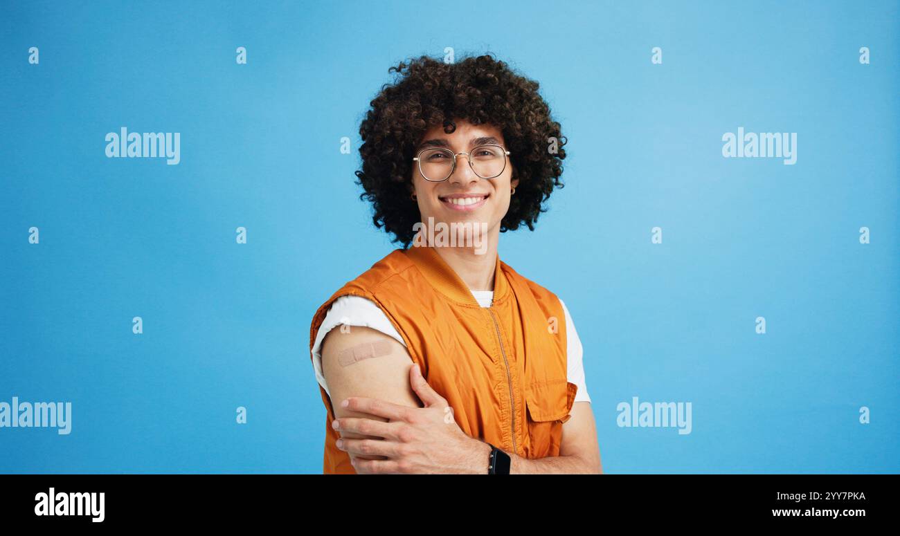 Man, portrait and plaster in studio for healthcare, injection wound and ...