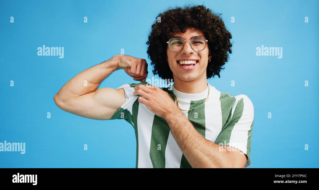 Studio, man and portrait with bicep for flex, muscle growth and ...